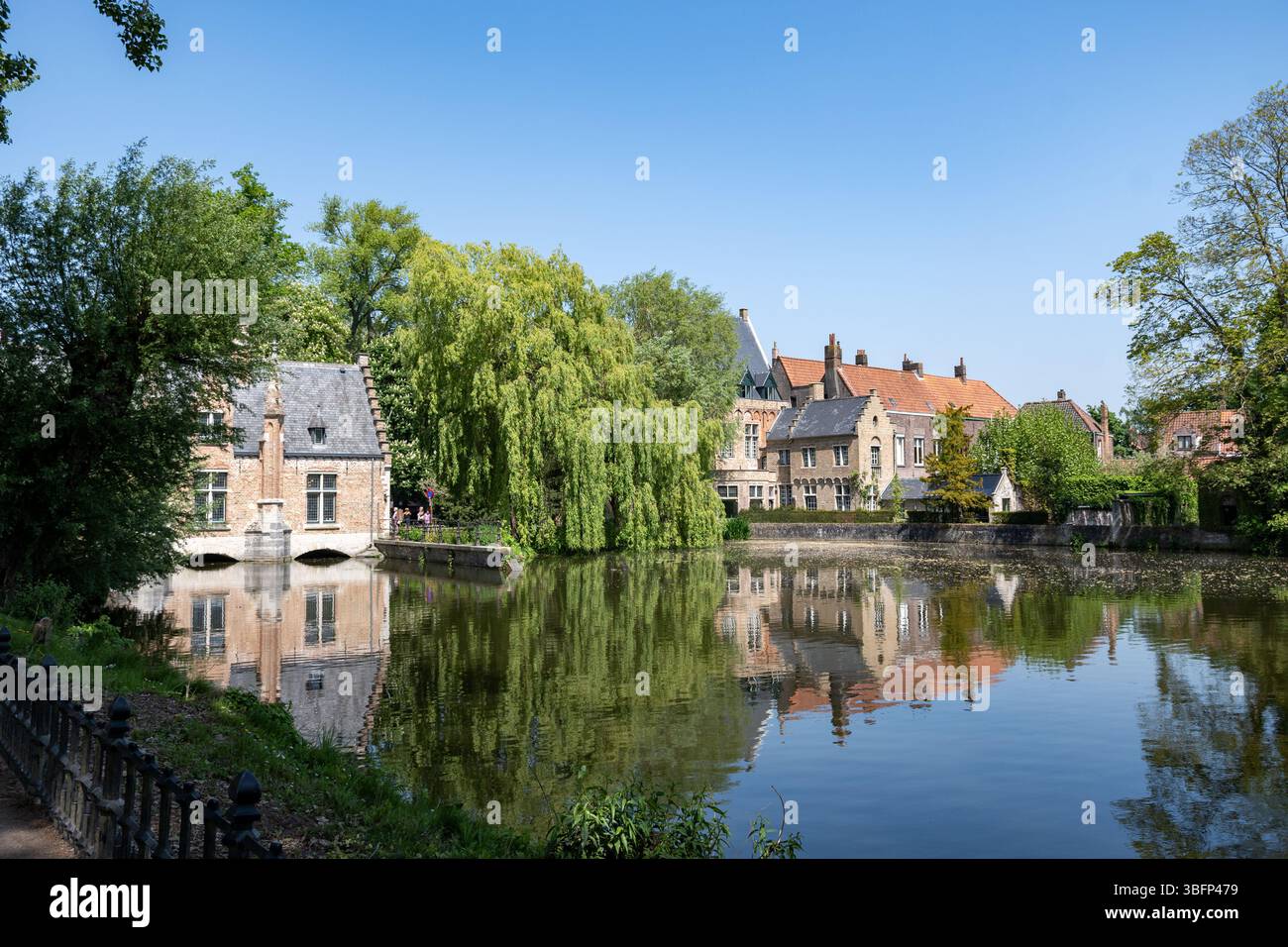Views of lake and city park with beautiful old buildings in Bruges town ...