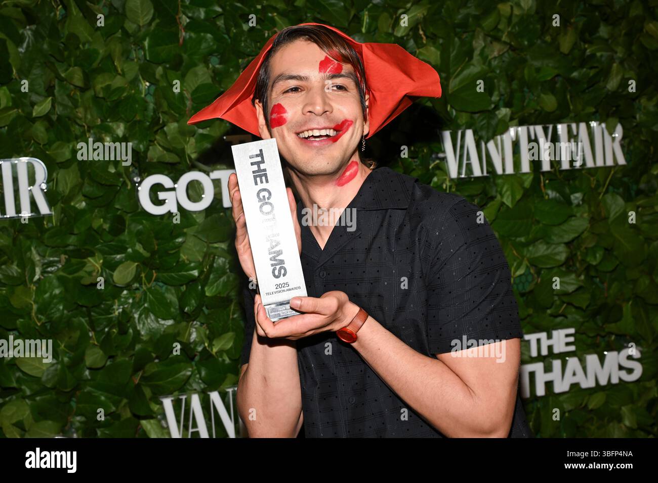 Julio Torres poses in the winner's room with the award for outstanding ...