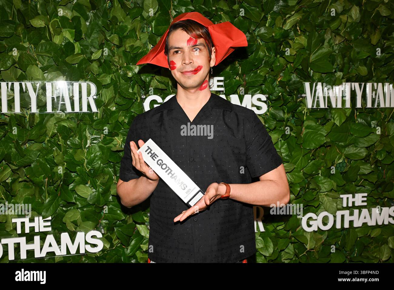 Julio Torres poses in the winner's room with the award for outstanding ...