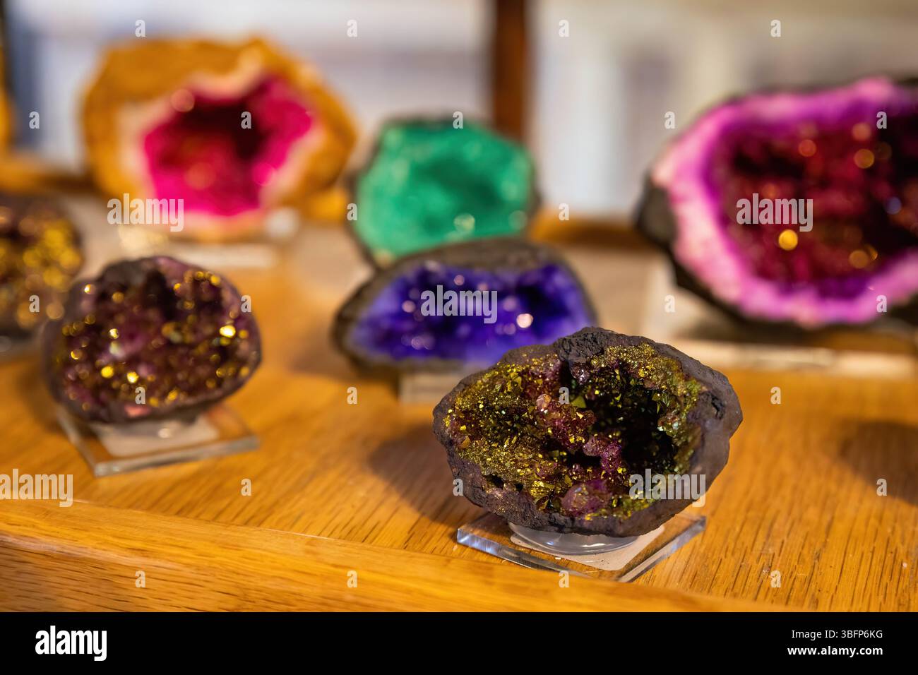Colorful geode stones cut open to reveal sparkling quartz crystal ...