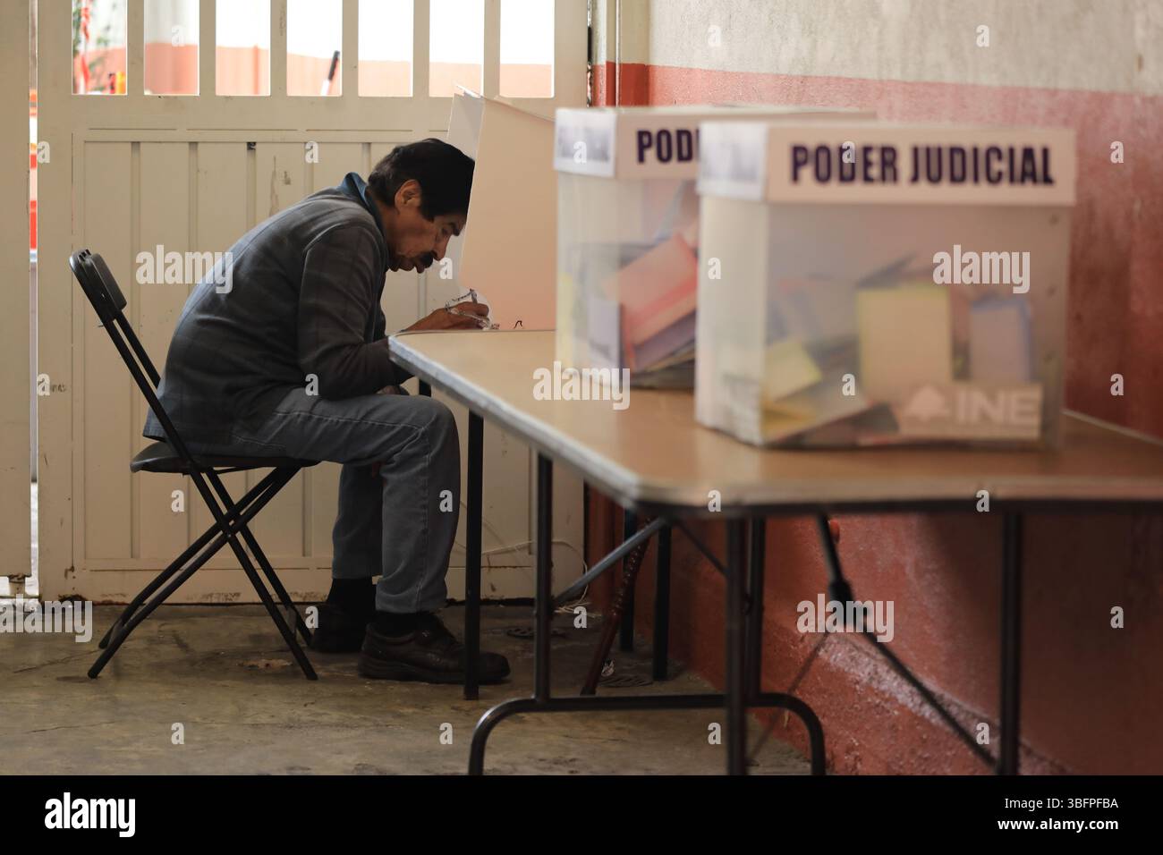 A Mexican citizen voting at polling station during the Judicial Branch ...