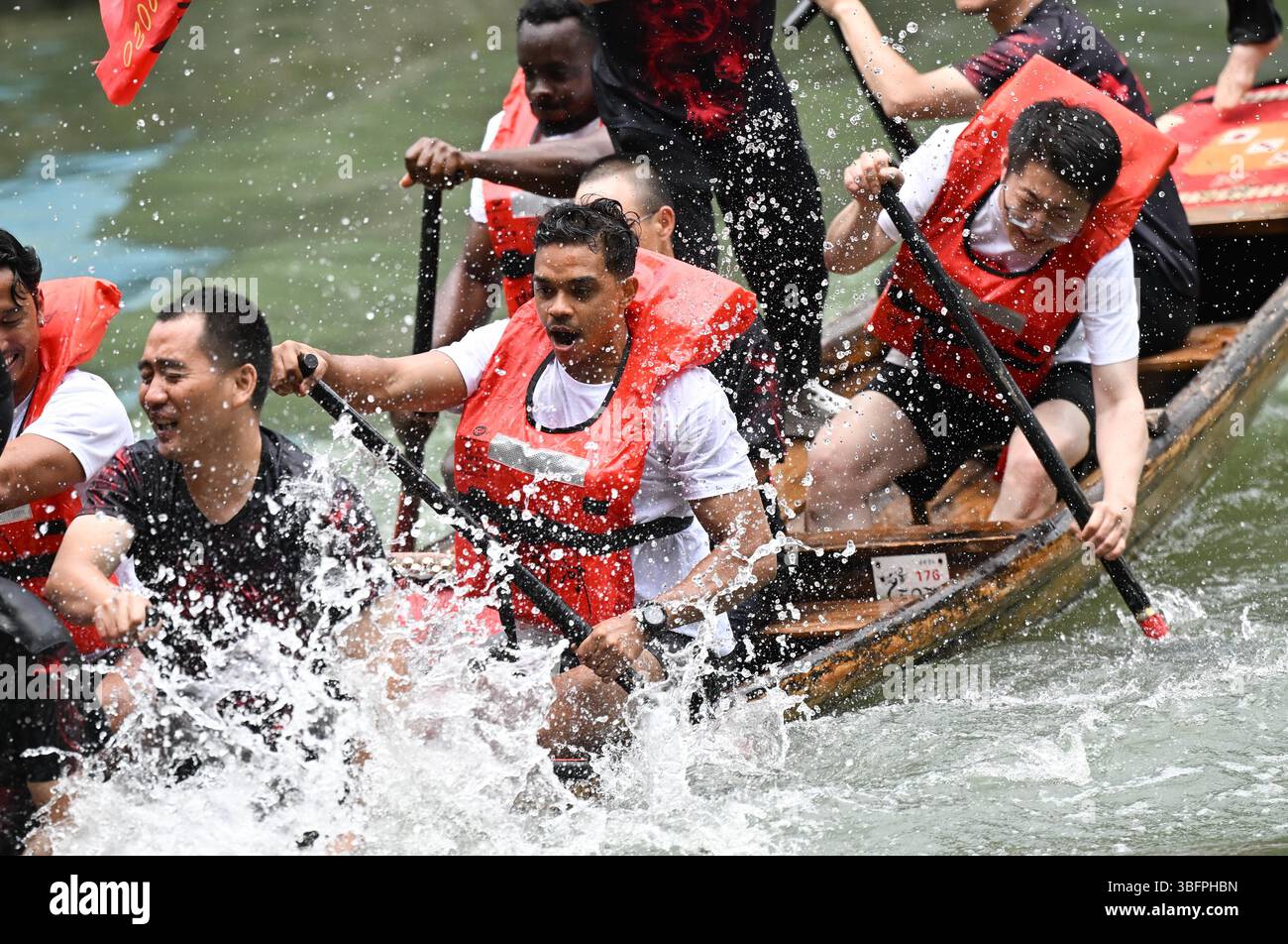 **CHINESE MAINLAND, HONG KONG, MACAU AND TAIWAN OUT** People row dragon ...