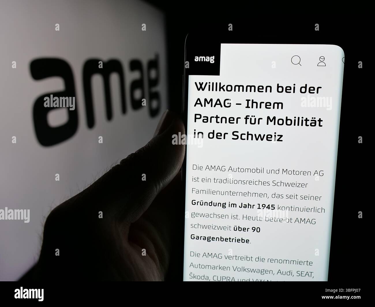 In this photo illustration, a person is holding a web page with the ...