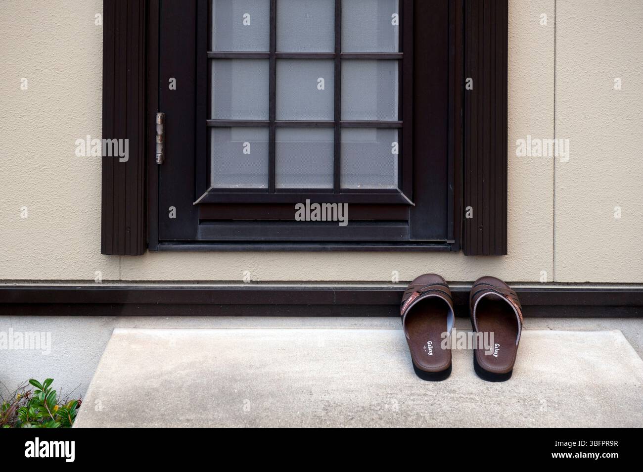 Pair of slippers outside the door of a residence speaks to the Japanese ...