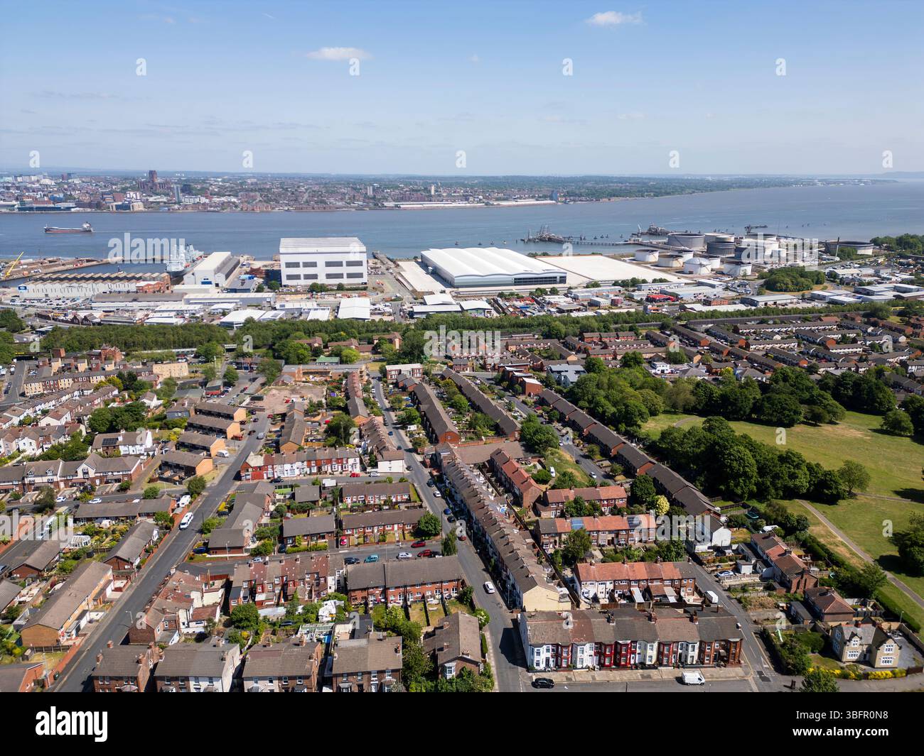 Birkenhead industrial waterfront and suburban housing on River Mersey ...