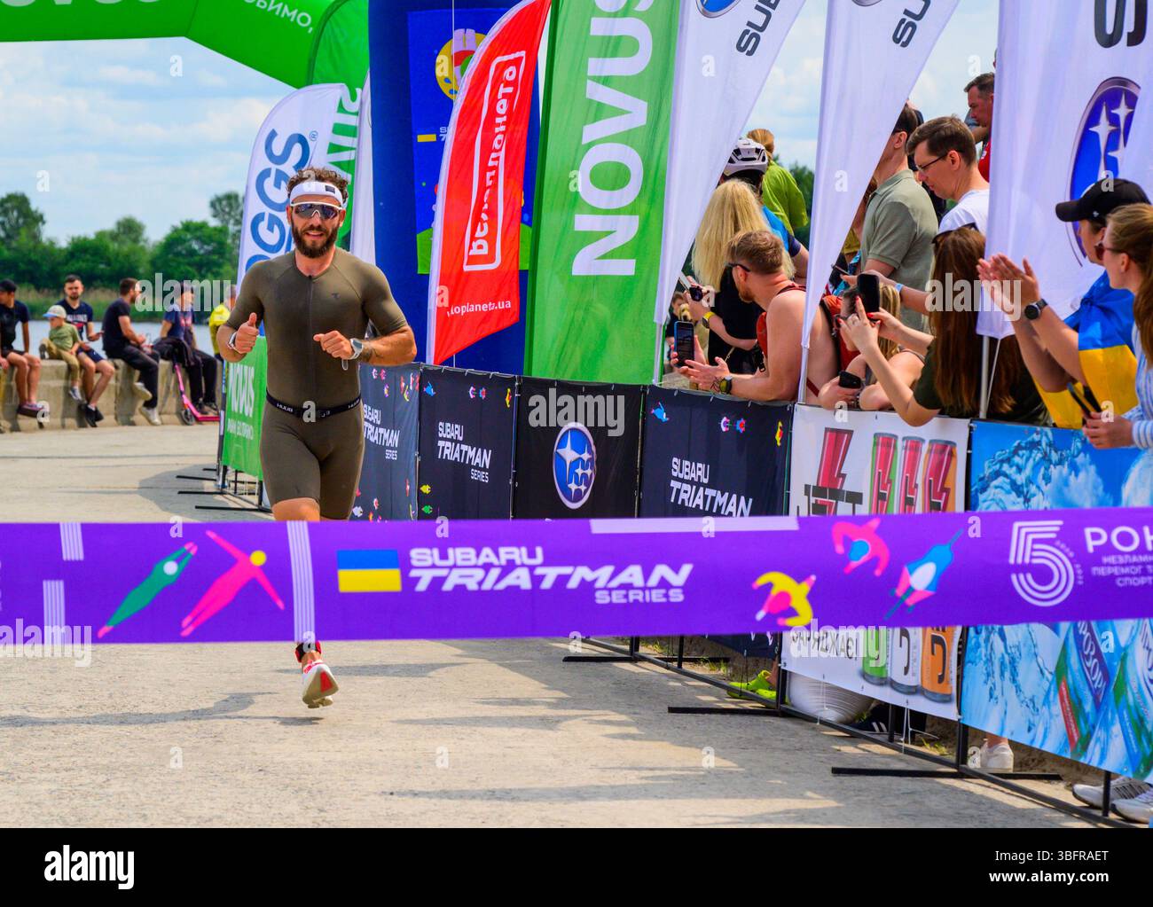 Kyiv, Ukraine - 1st June, 2025: Male triathlete running and crossing ...