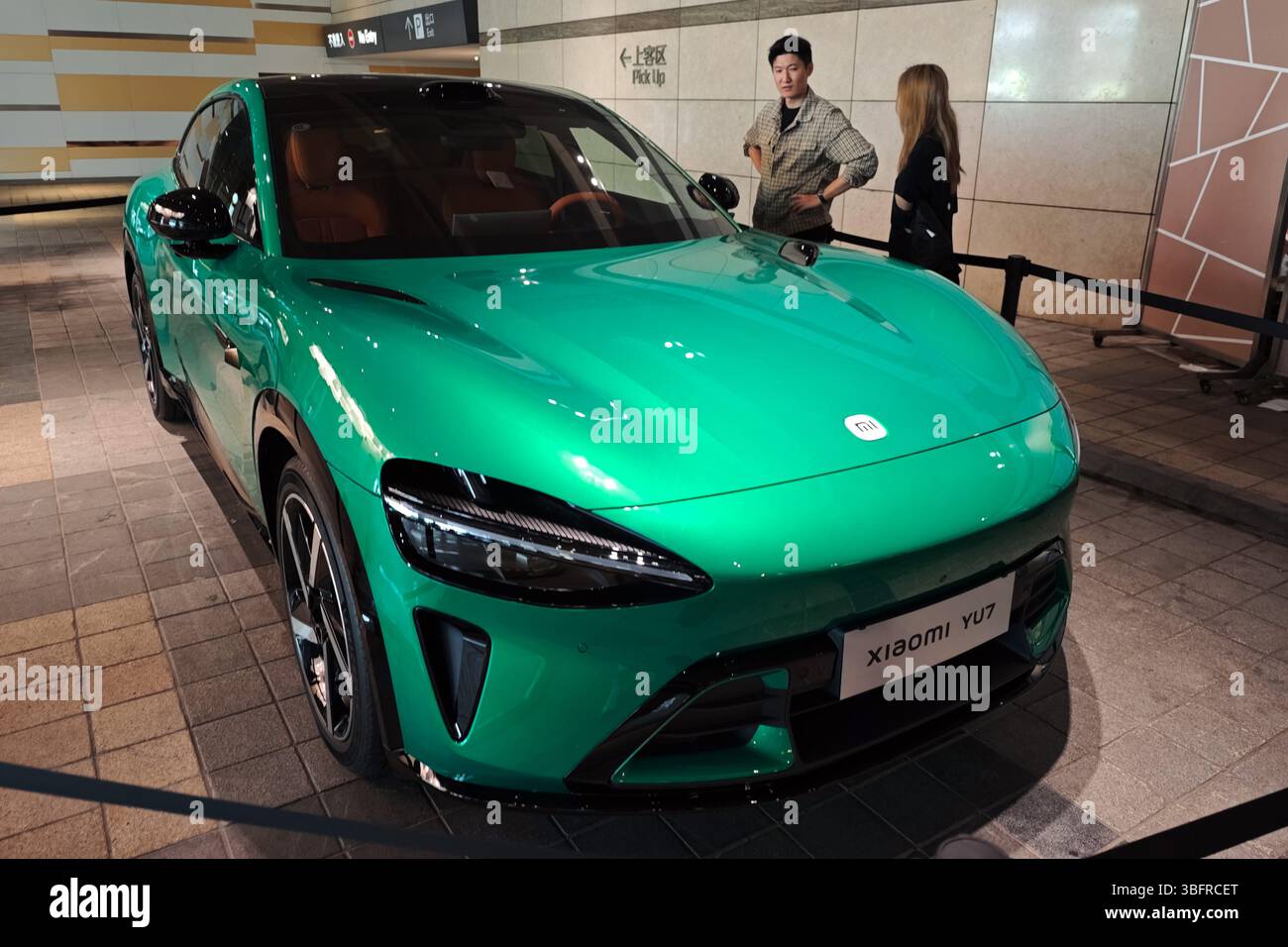 Tourists are watching a Xiaomi YU7 electric vehicle in the iapm of the China World Trade Center ...