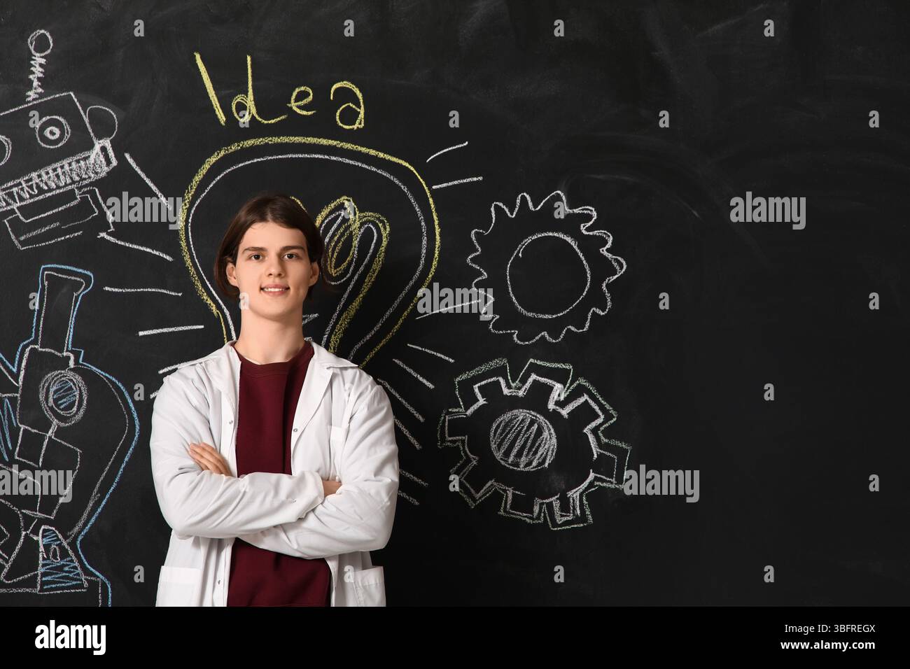 Male inventor near drawings on dark wall Stock Photo - Alamy