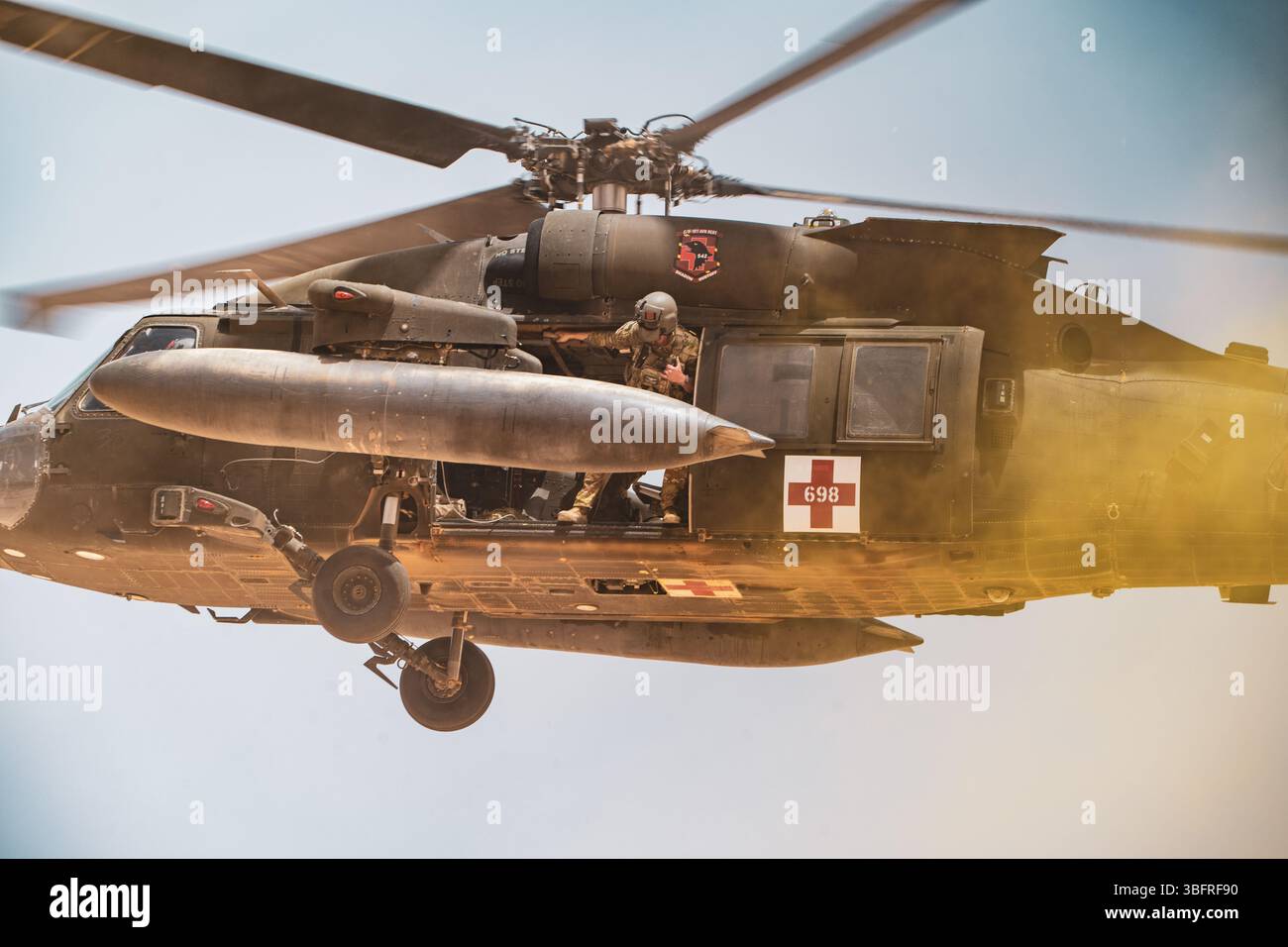 A U.S. Army air crew member of a HH-60M Blackhawk maintains visual ...