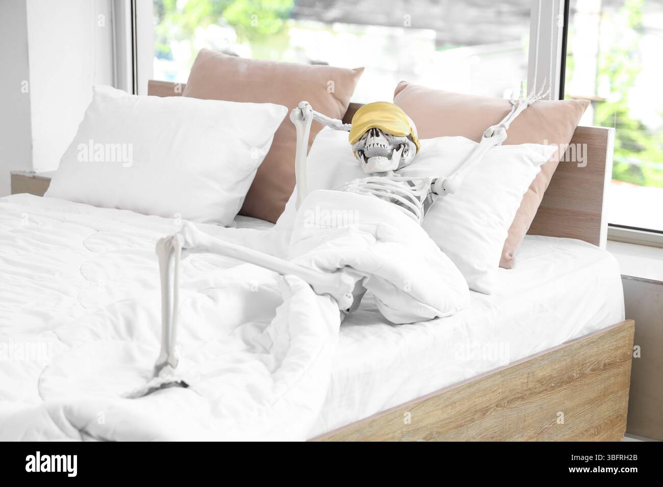 Human skeleton with sleeping mask lying in bedroom Stock Photo - Alamy