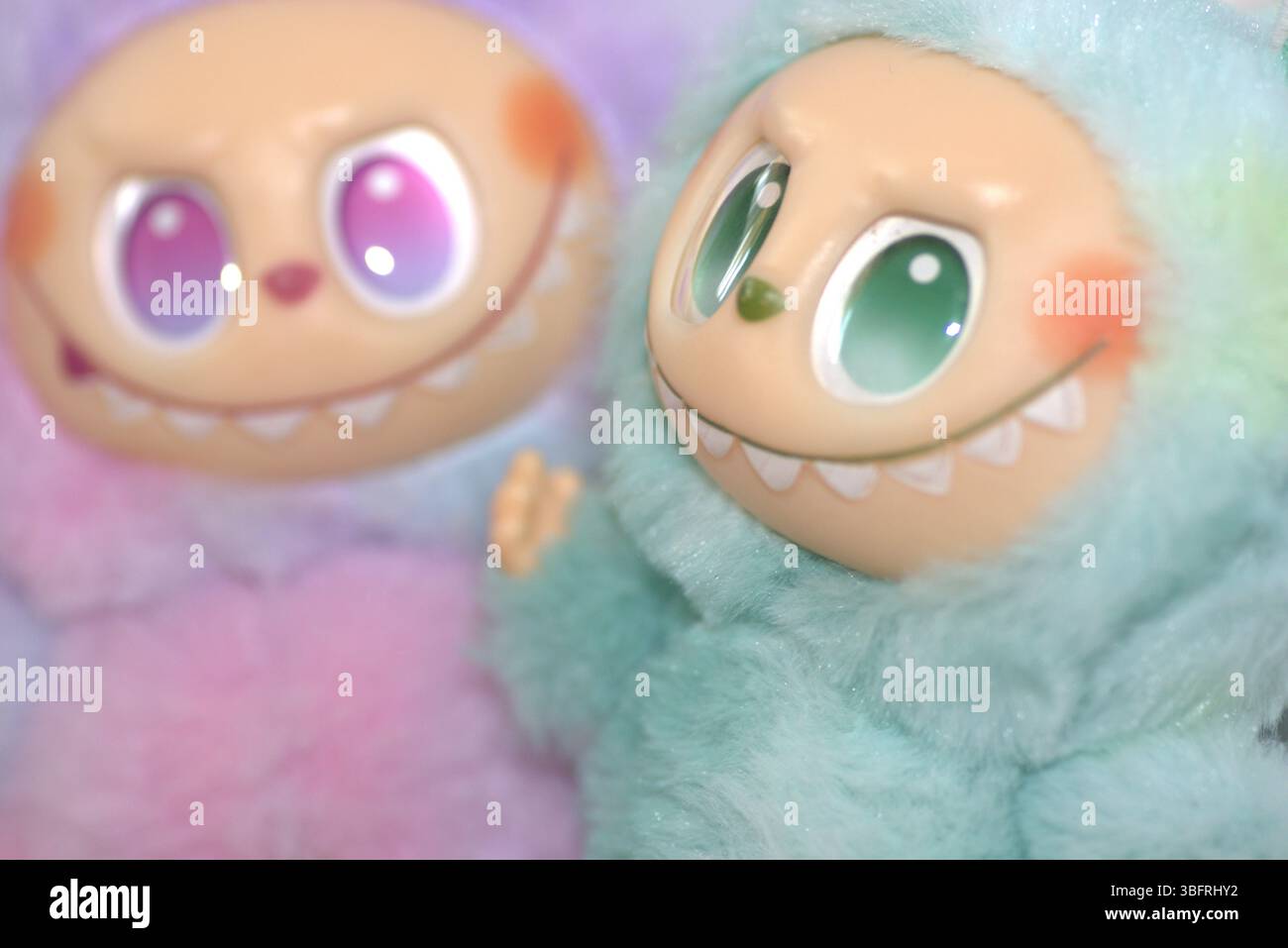 Two playful Labubu toy figures in a fluffy green and pink monster ...