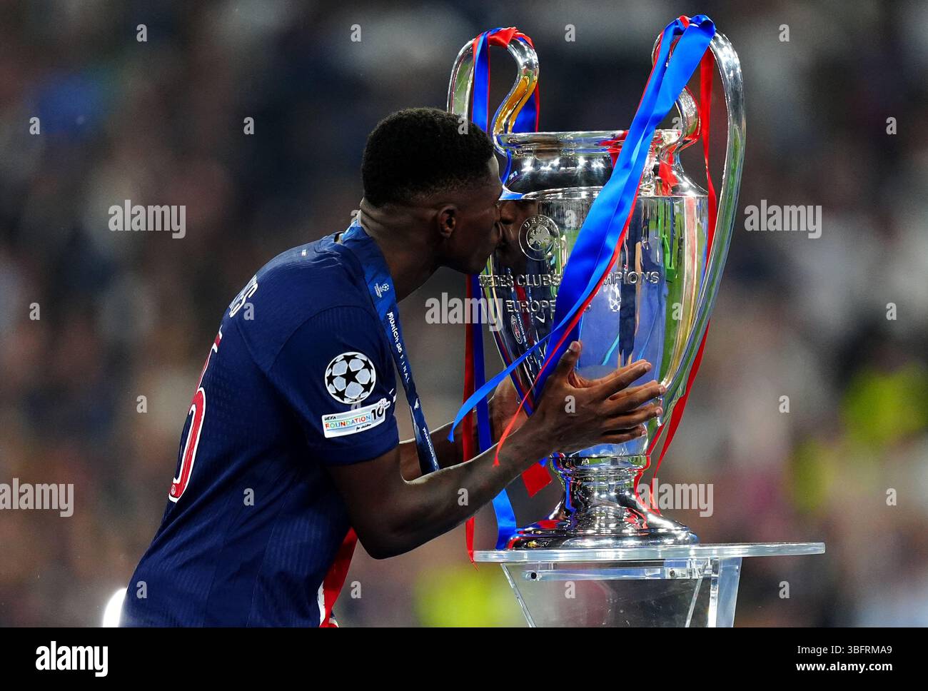 Paris Saint Germain's Alexandre Nuno Mendes with the trophy following ...