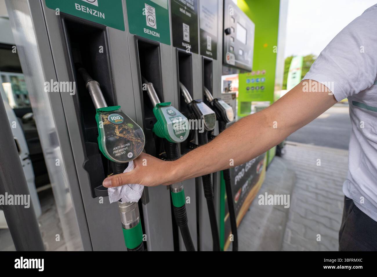 03 June 2025, Czech Republic, Asch: A man reaches for the pump at a ...