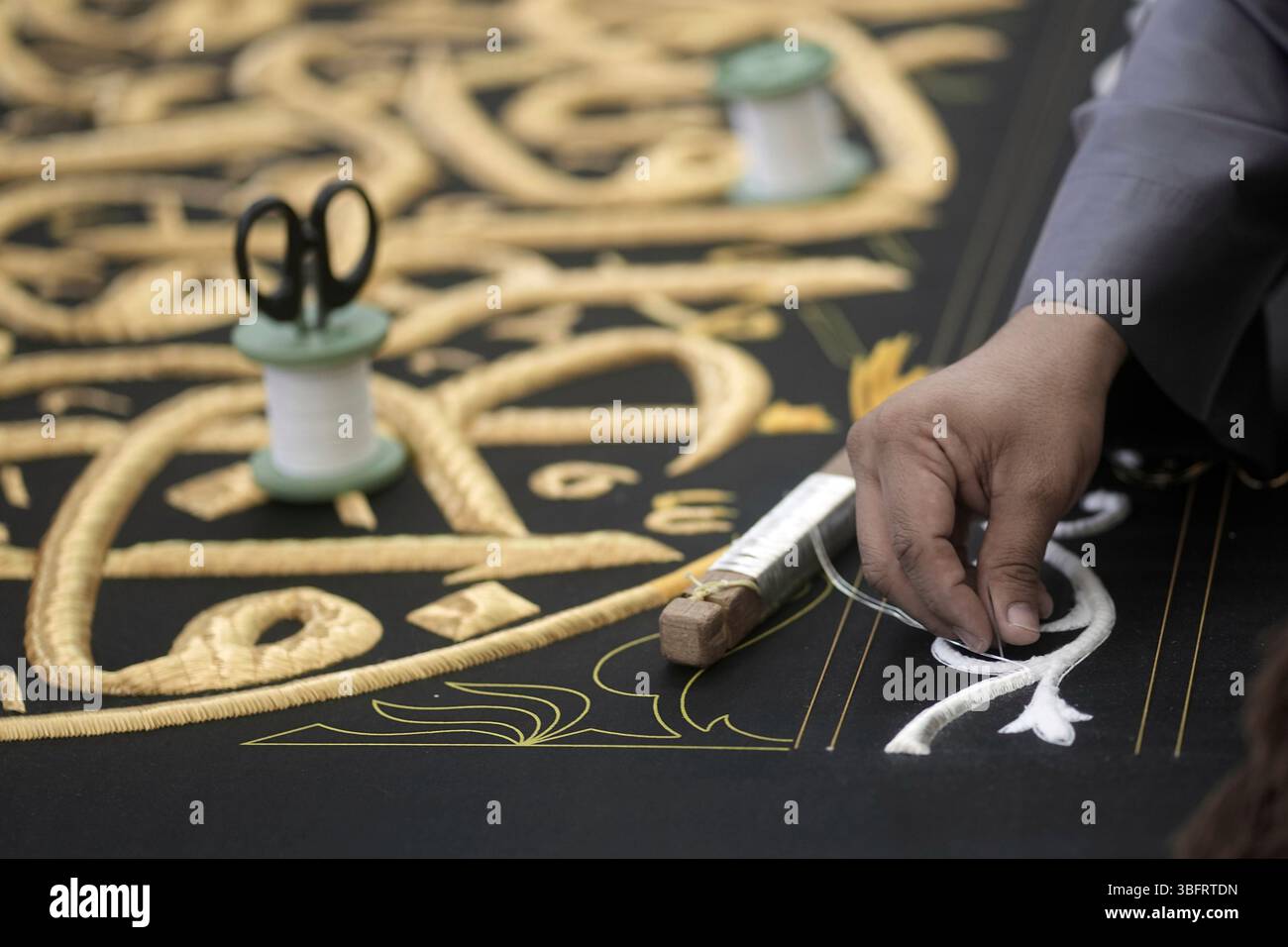 Saudi workers embroider Islamic calligraphy, using either pure silver ...