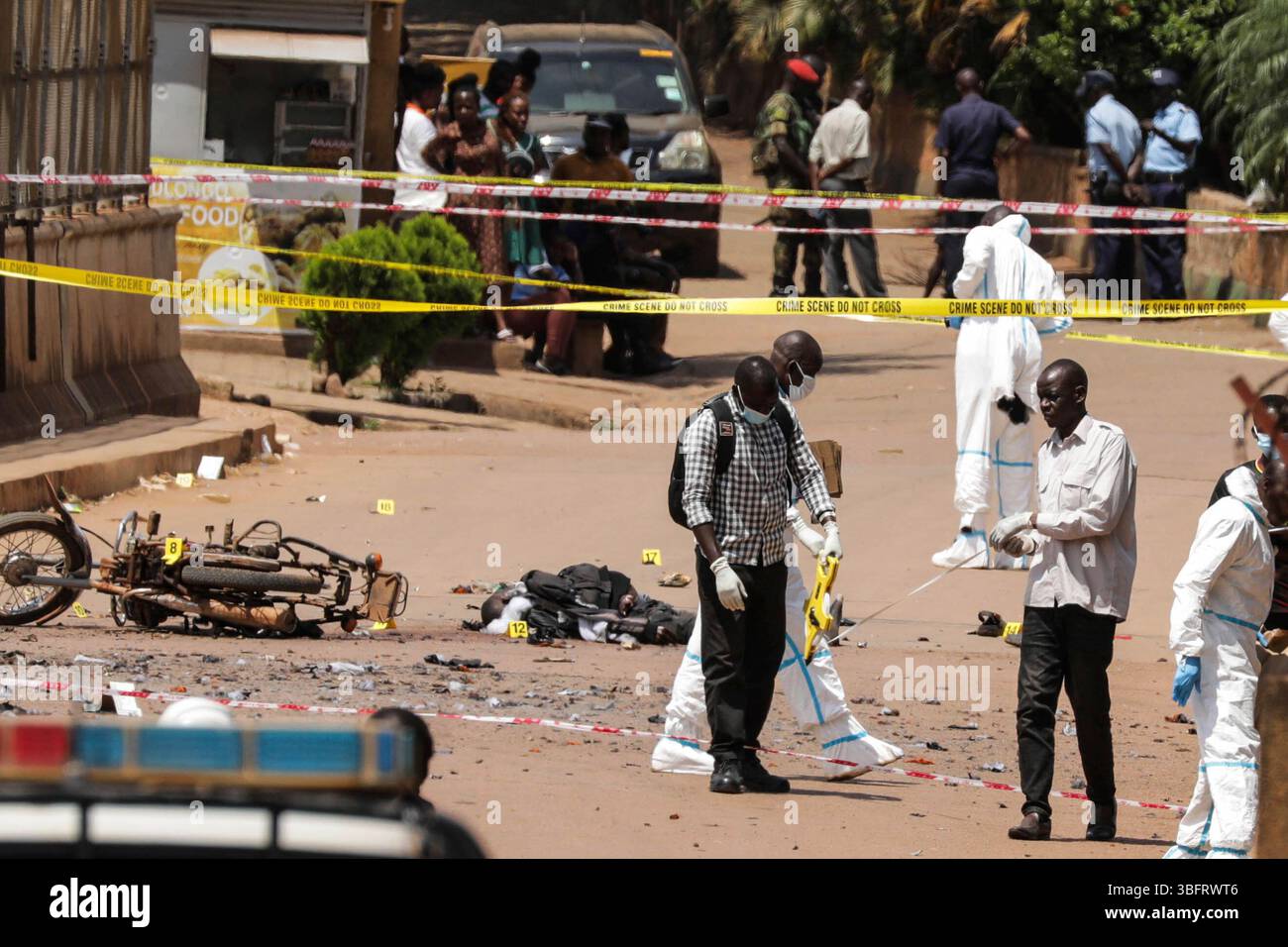 Detectives and forensic investigators work at the scene of a suspected ...