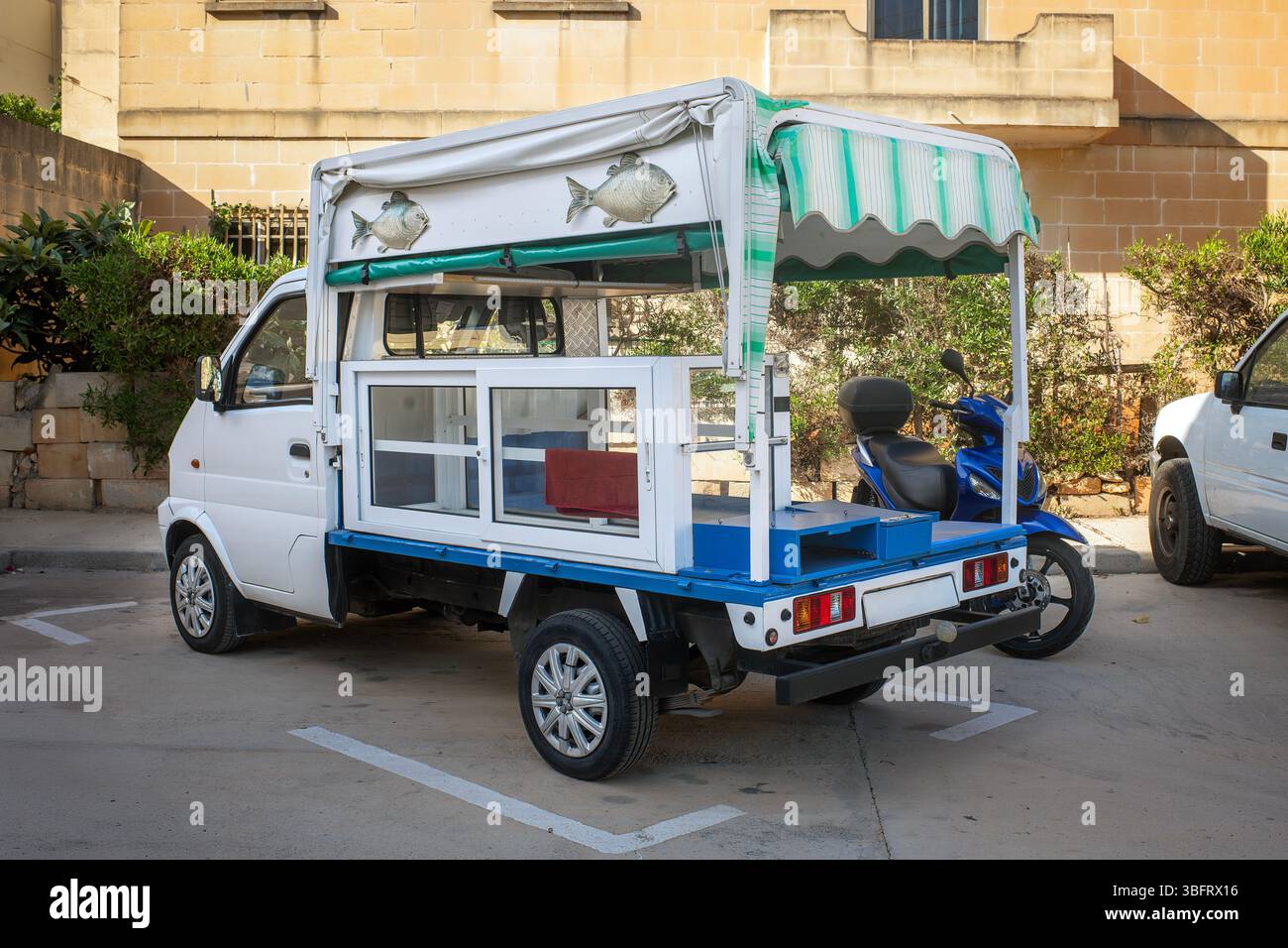Zabbar, Malta- 06.01.2025: Small fish delivery truck with a striped ...