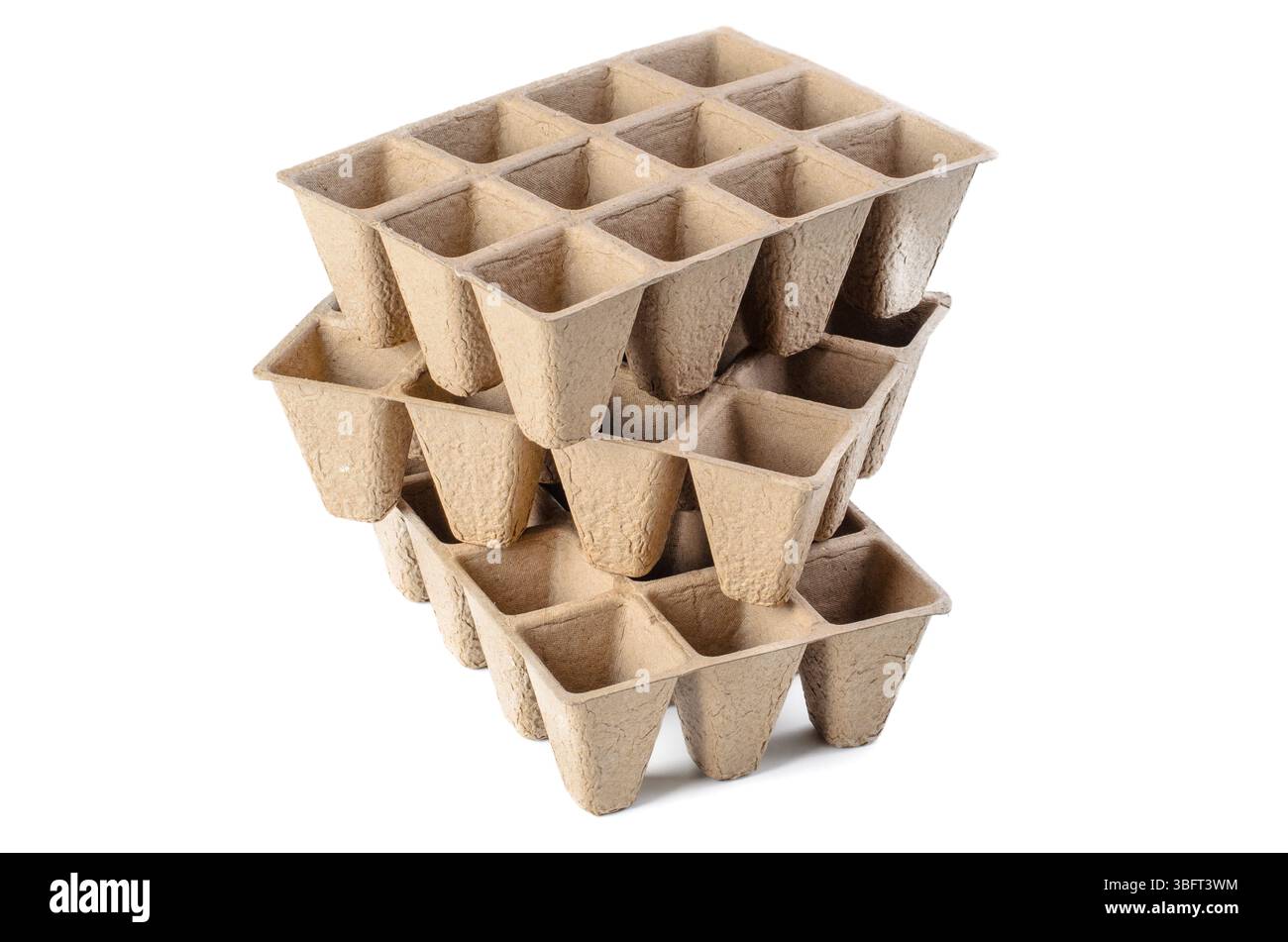 Biodegradable plant trays stacked together for space-saving gardening ...
