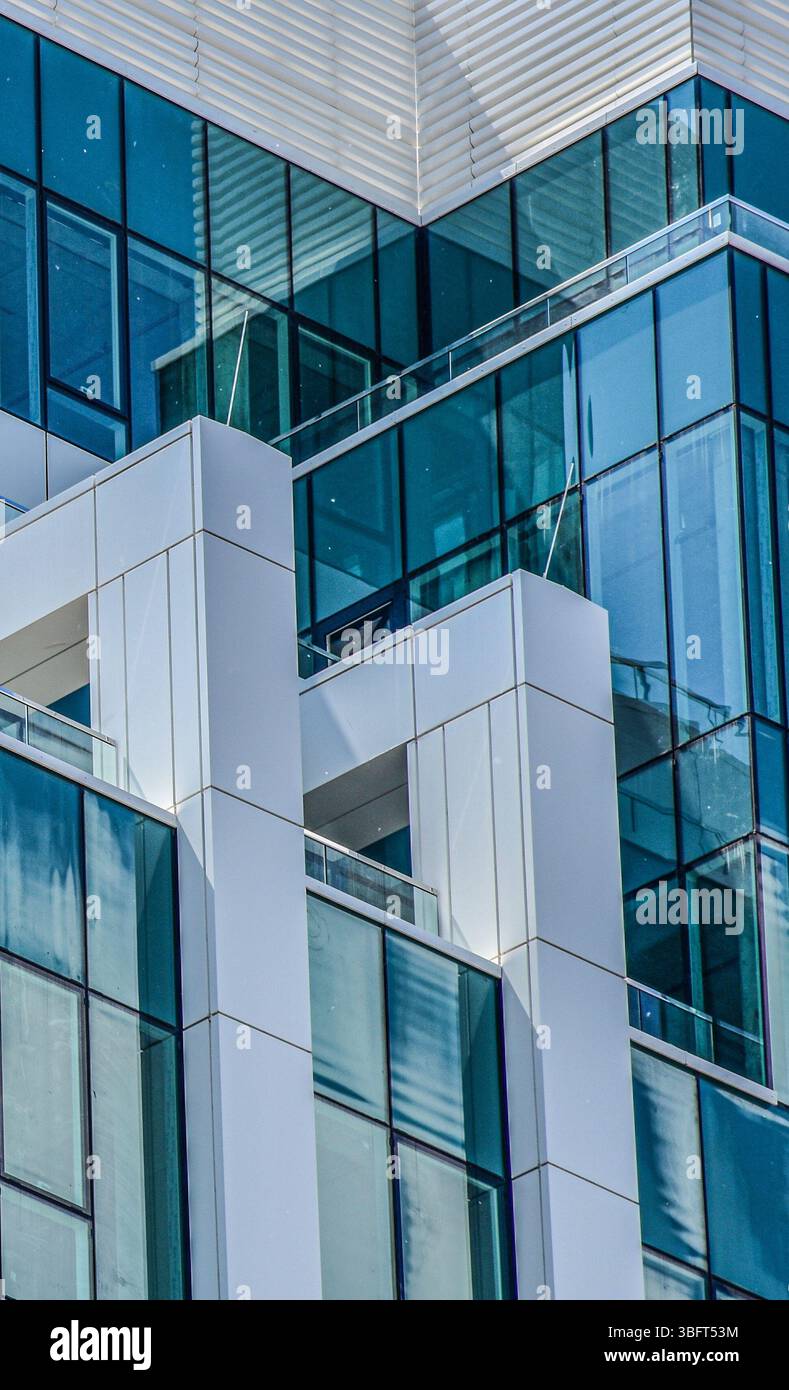 Abstract modern building facade made of glass and metal with strong ...
