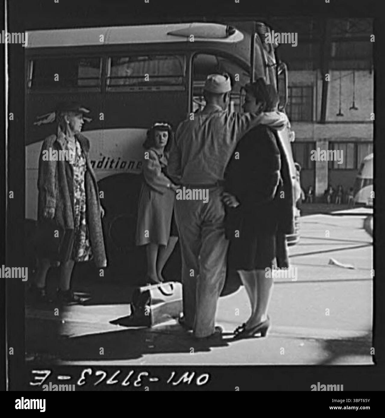 Photograph of a soldier and a girl saying goodbye at the Greyhound bus ...
