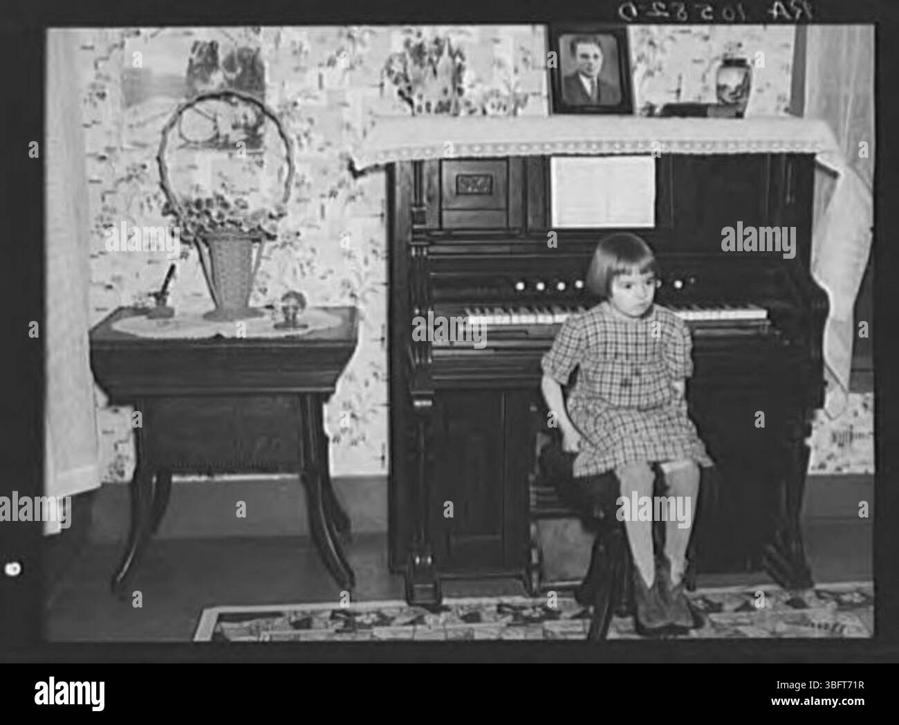 Photograph of a Tip Estes family member sitting in the living room at 7 ...