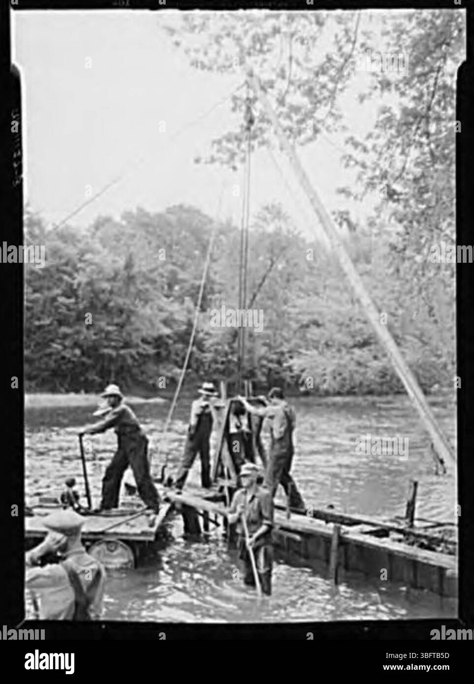 This image shows a homemade pile driver being used to construct a wing ...