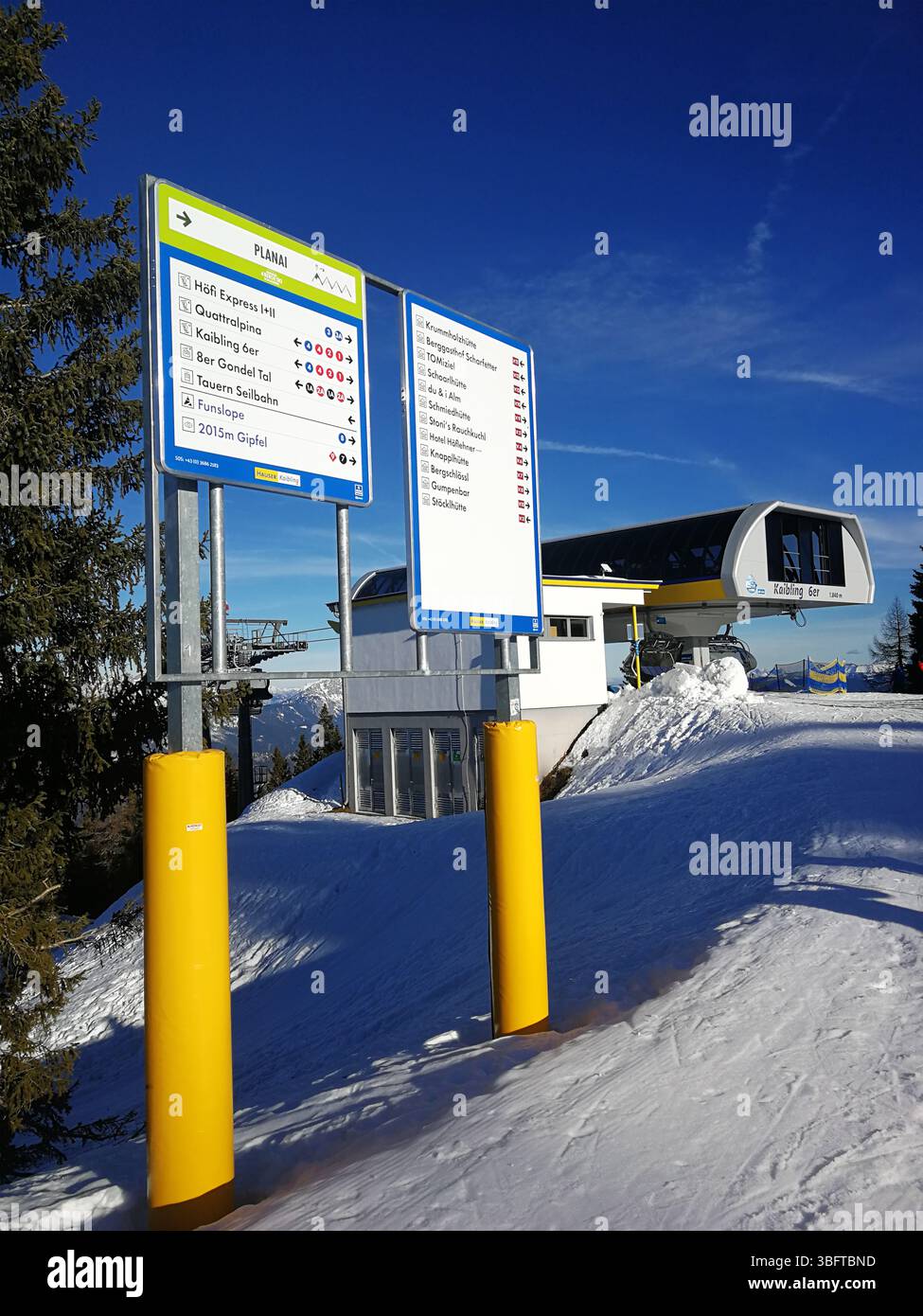 Ski Resort Signage With Snow and Chairlift Under a Clear Blue Sky ...