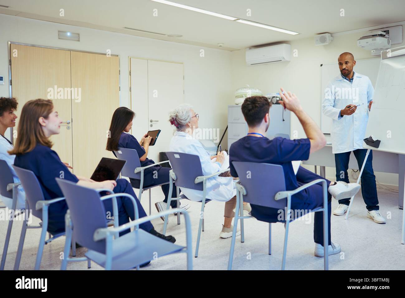 Medical team attending a conference in modern hospital setting Stock ...