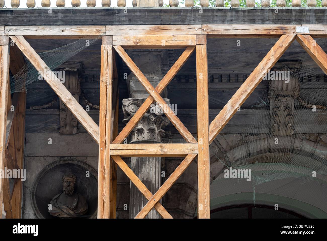 Wooden scaffolding supporting an old historic building facade with ...