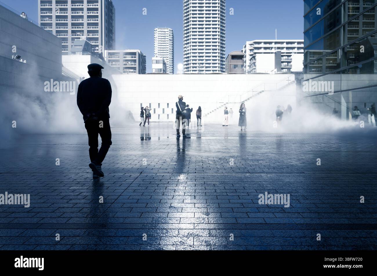 Visitors wander through a mist installation in the MOT Tokyo, part of ...