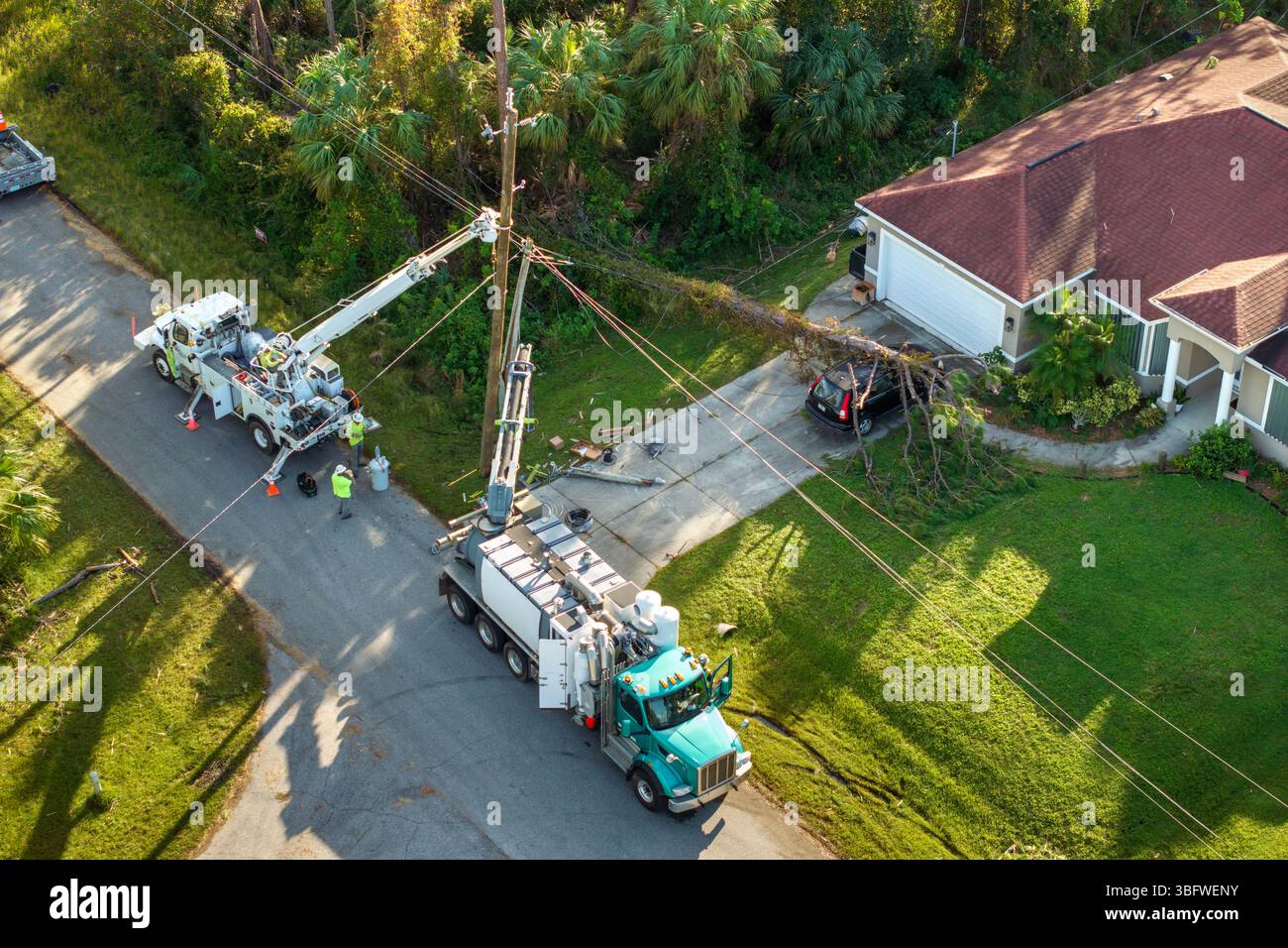 Aerial view of electrician workers repairing damaged power lines after ...