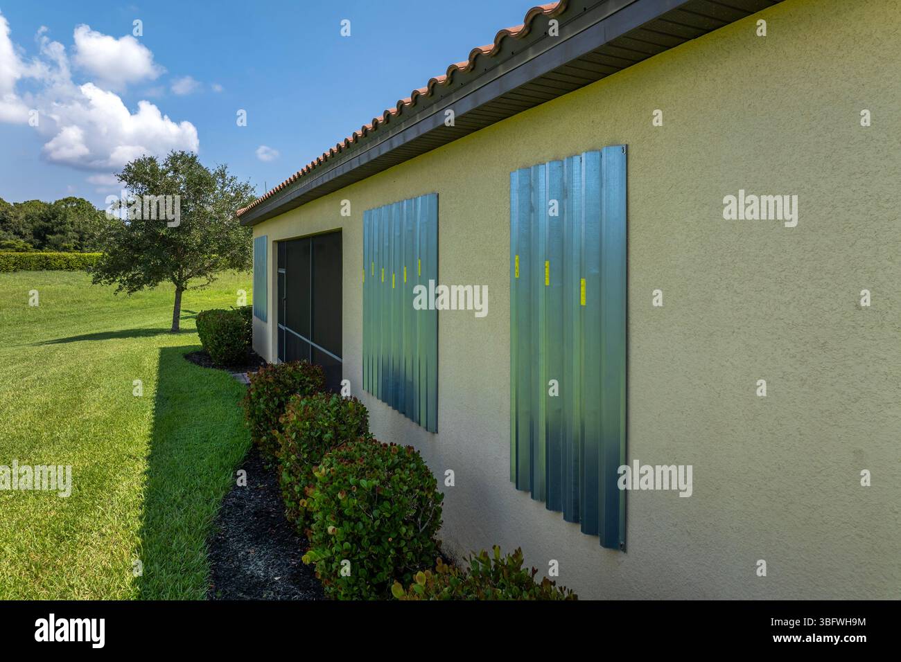 Boarded up windows with steel storm shutters for hurricane protection ...