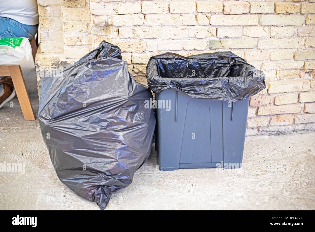 recycling bag next to a general waste bin. environment Stock Photo - Alamy