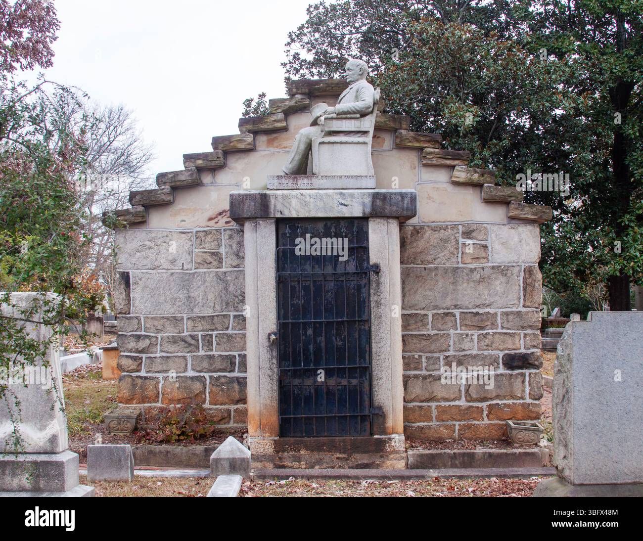 Mausoleum of Jasper Smith features its occupant in granite, sitting in a chair above the ...