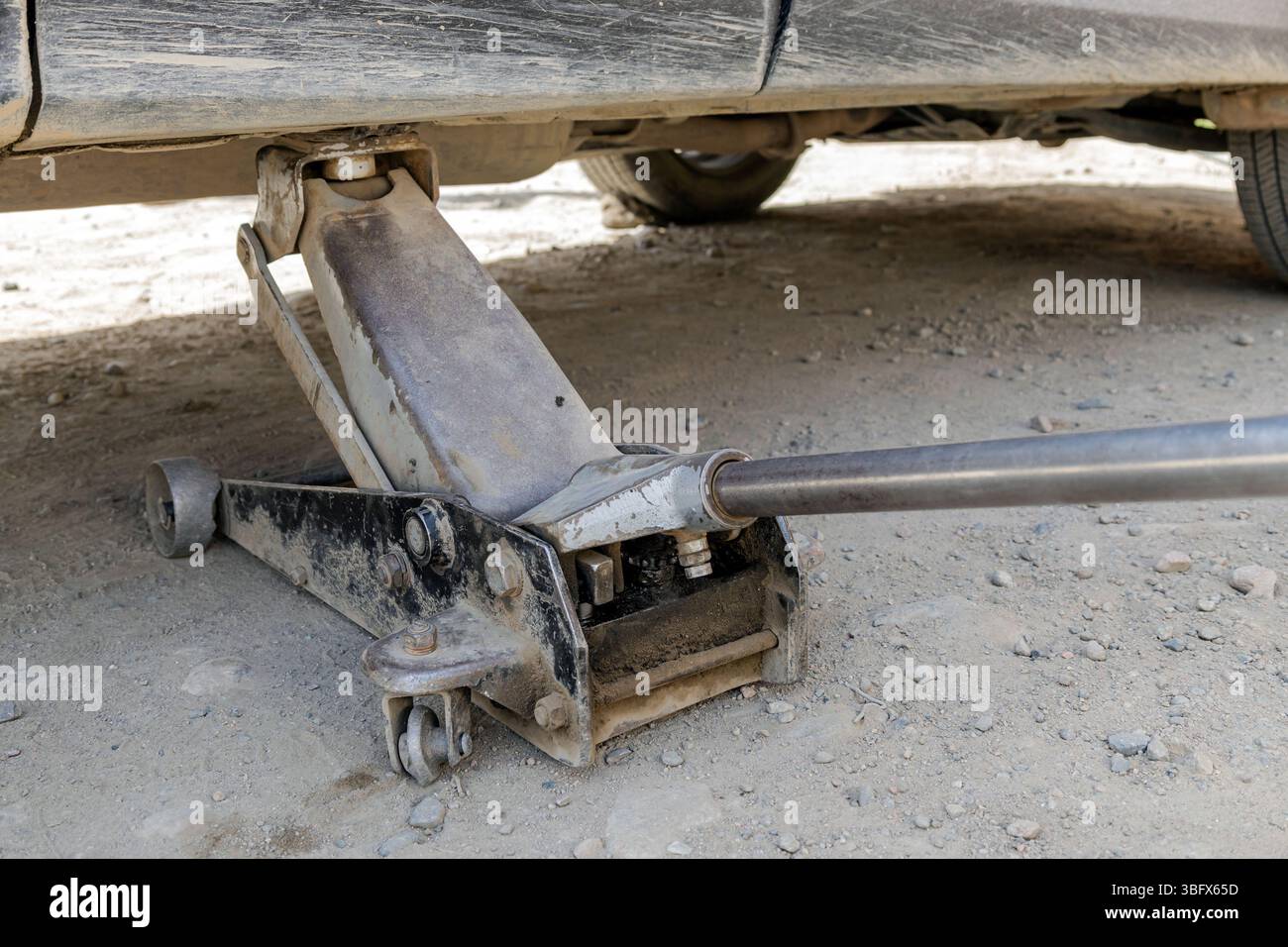 Tire fitting process, trolley jack lifts the car Stock Photo - Alamy