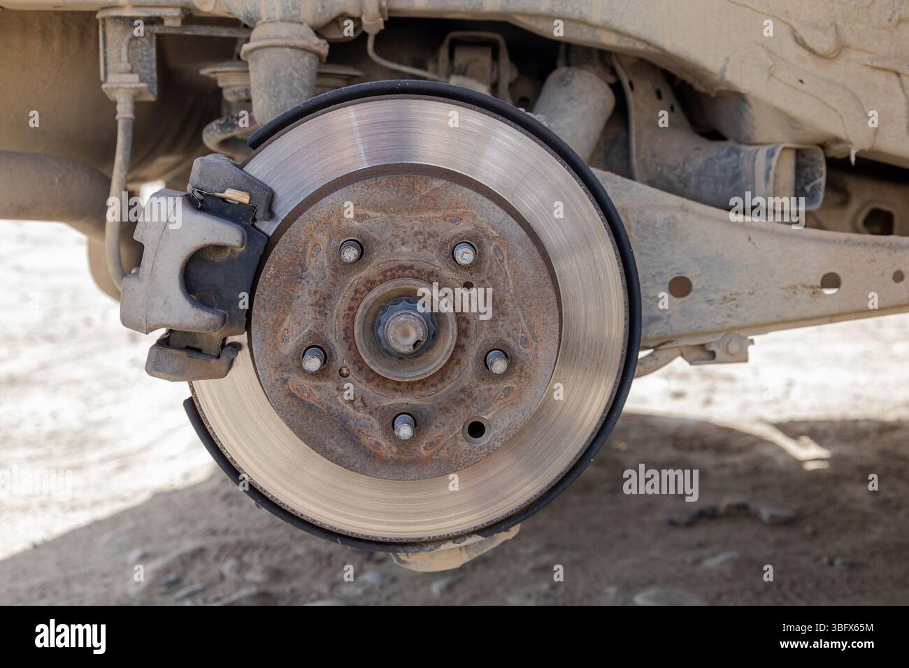 Car brake disc with caliper and wheel hub front view. The removed car ...
