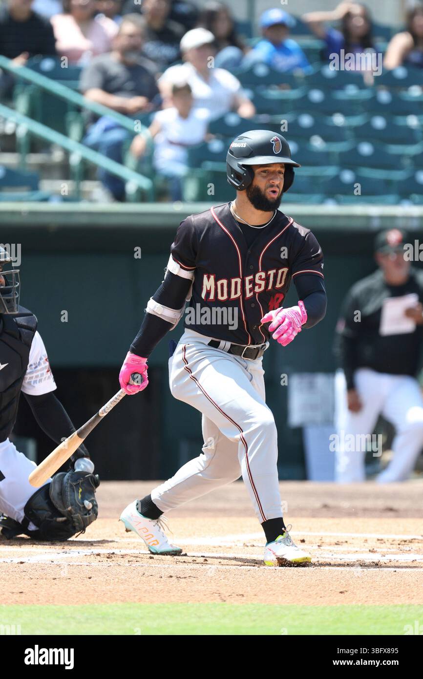 Carlos Jimenez (18) of the Modesto Nuts bats against the Inland Empire ...