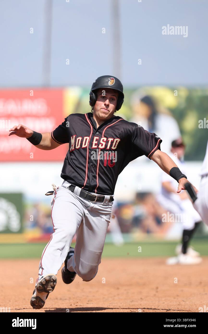 Carter Dorighi (10) of the Modesto Nuts slides into third base against ...