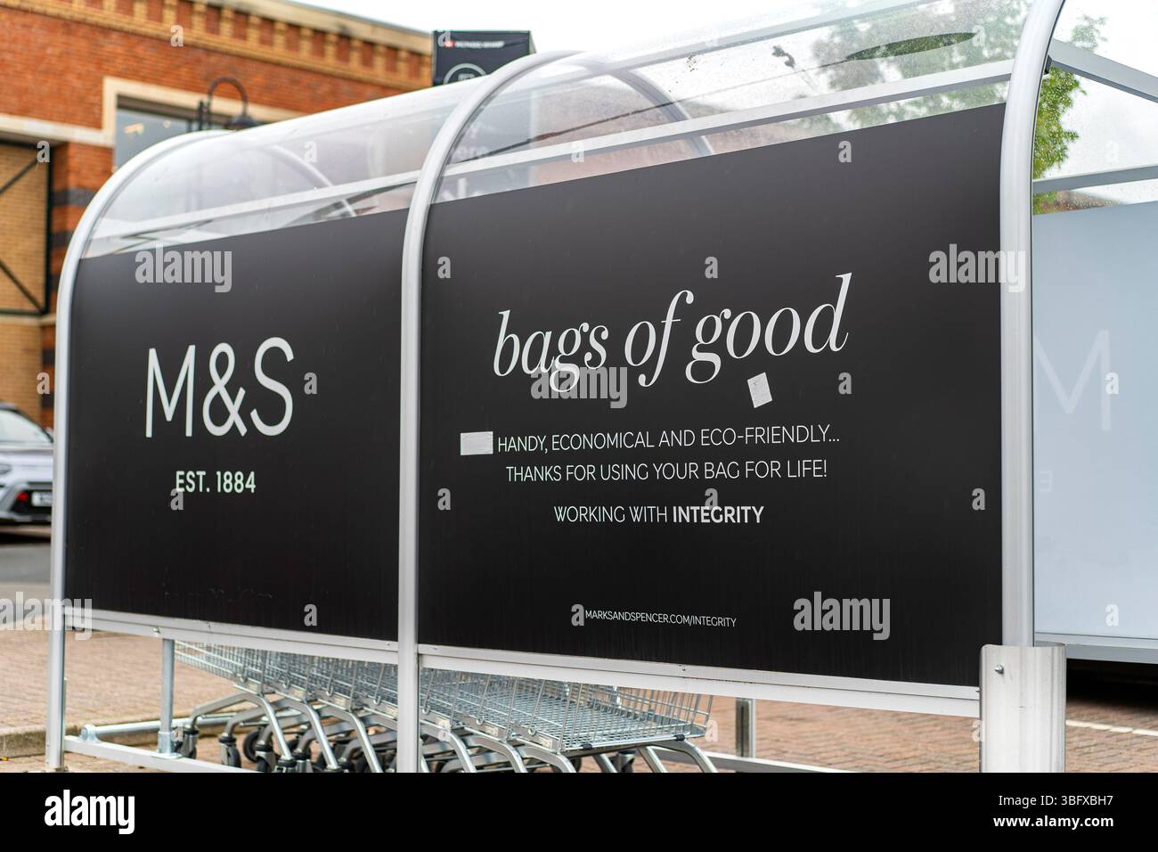 Shopping trolly shelter outside a Marks and Spencer store. The trolly ...