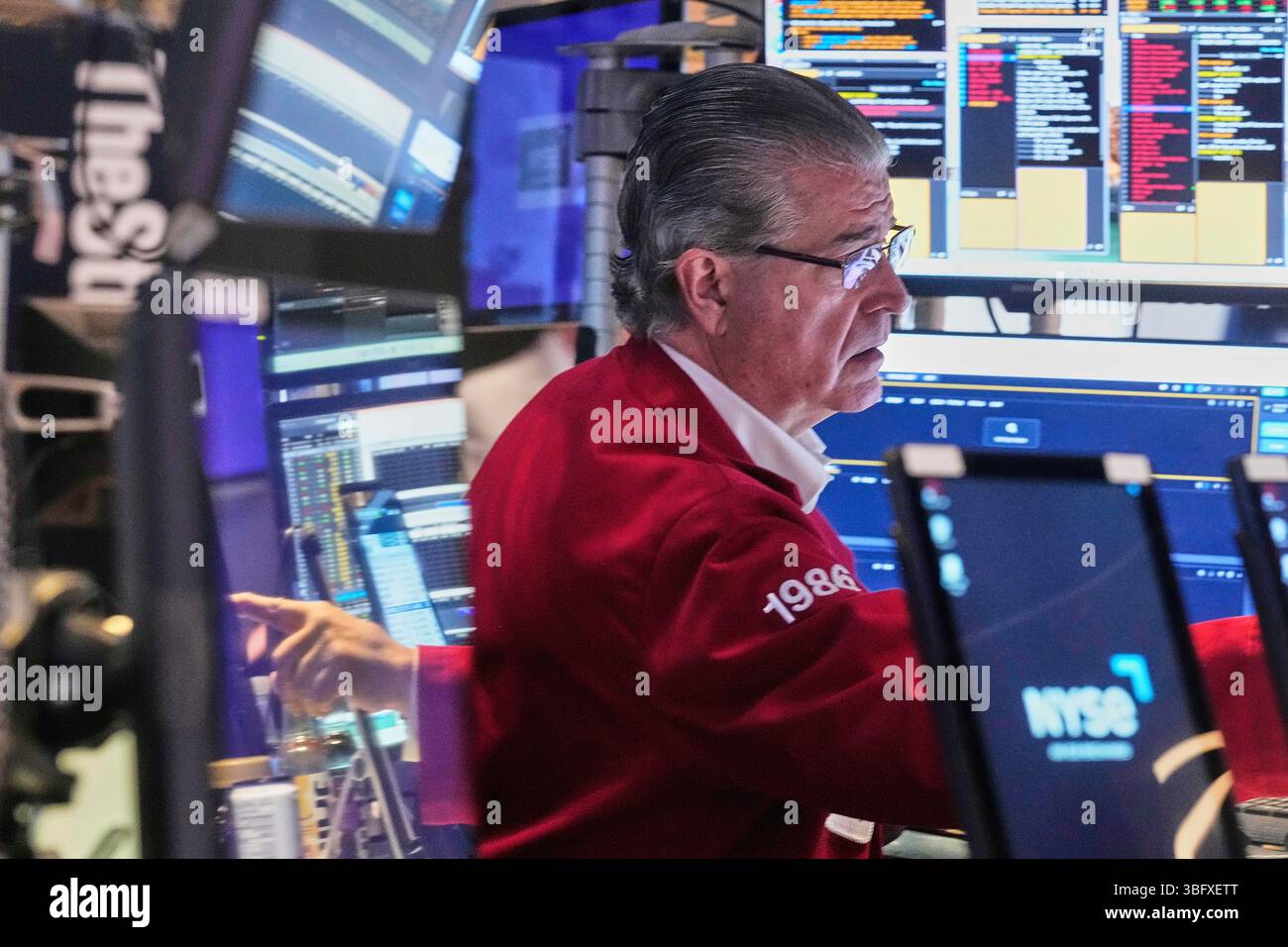 Trader Daniel Kryger works on the floor of the New York Stock Exchange ...