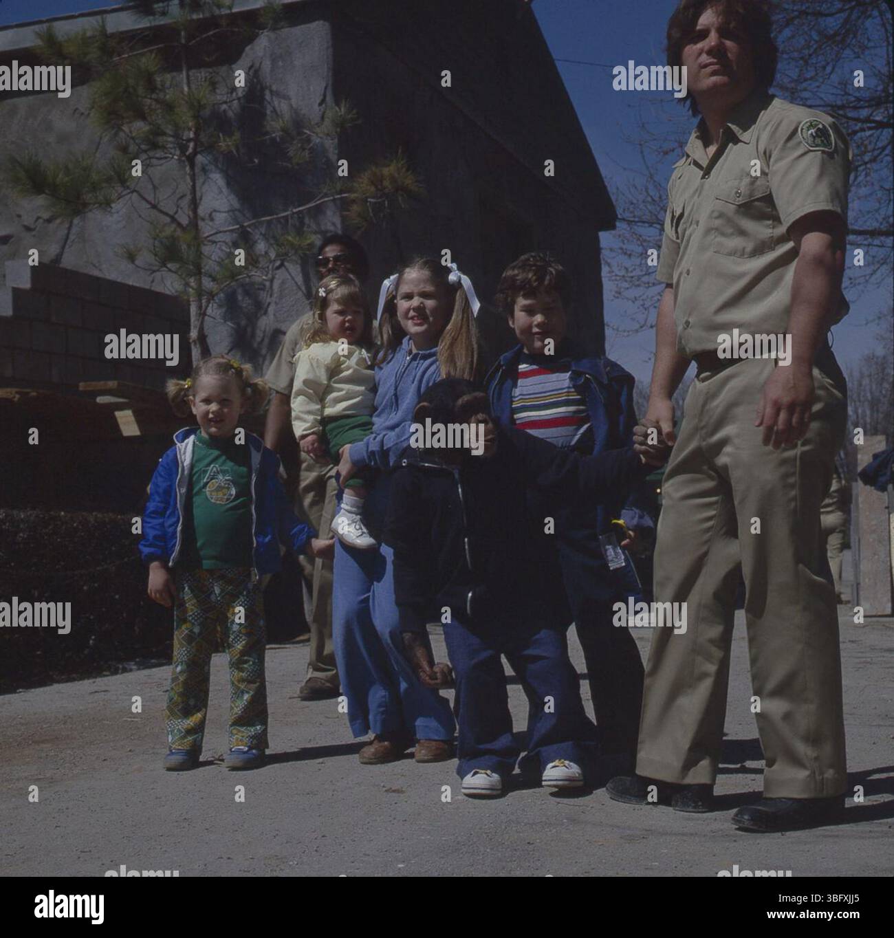 Visitors to the Columbus Zoo are pictured alongside a chimpanzee ...