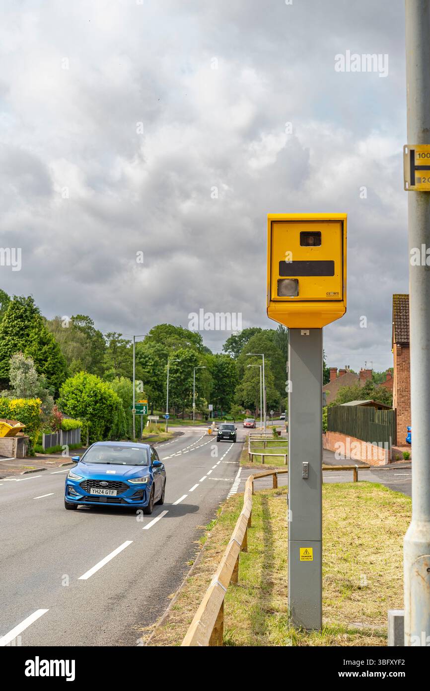 Car with L plates driving past yellow Gatso traffic enforcement camera ...