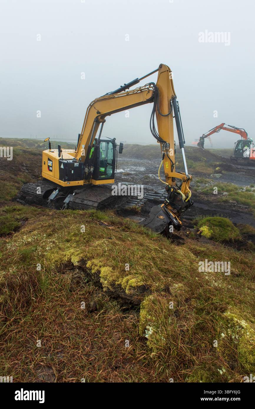Peat restoration underway in foggy hill conditions, with diggers ...