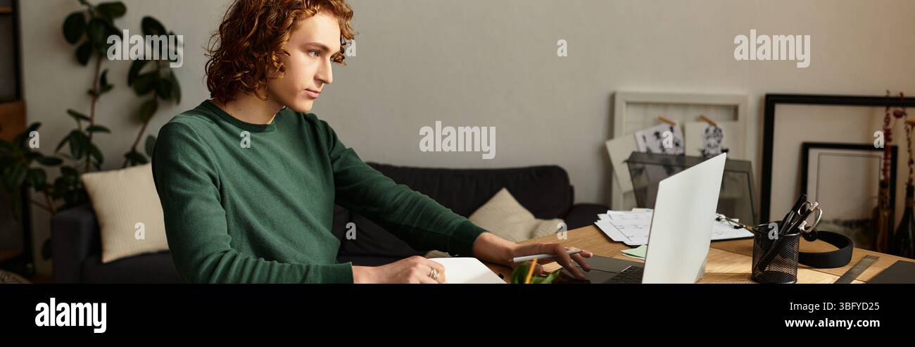 Handsome young man with curly hair focuses on his laptop while writing ...