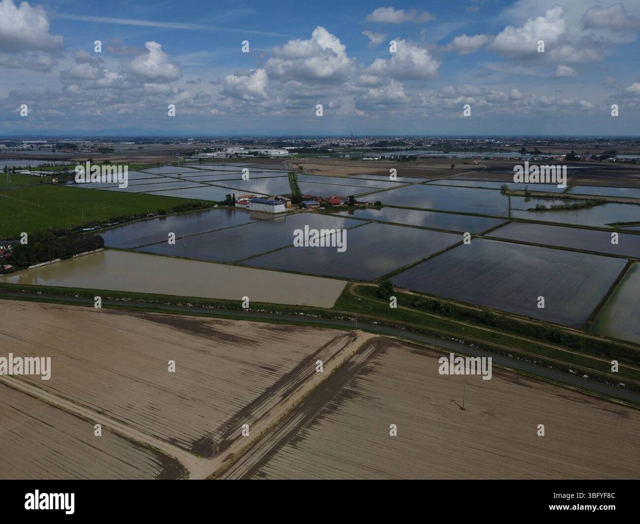 Drone view of Novara’s countryside with flooded rice fields reflecting ...