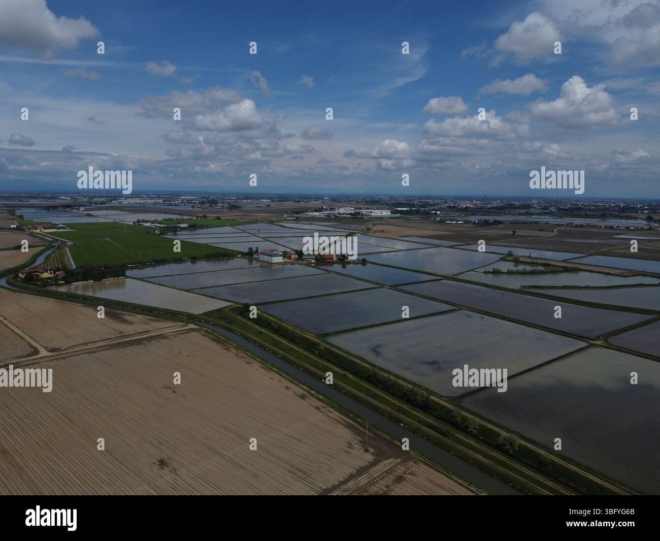 Drone view of Novara’s countryside with flooded rice fields reflecting ...