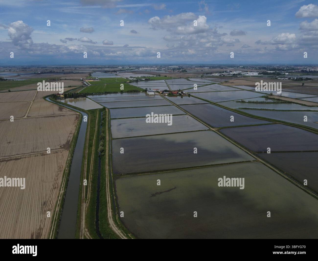 Drone view of Novara’s countryside with flooded rice fields reflecting ...