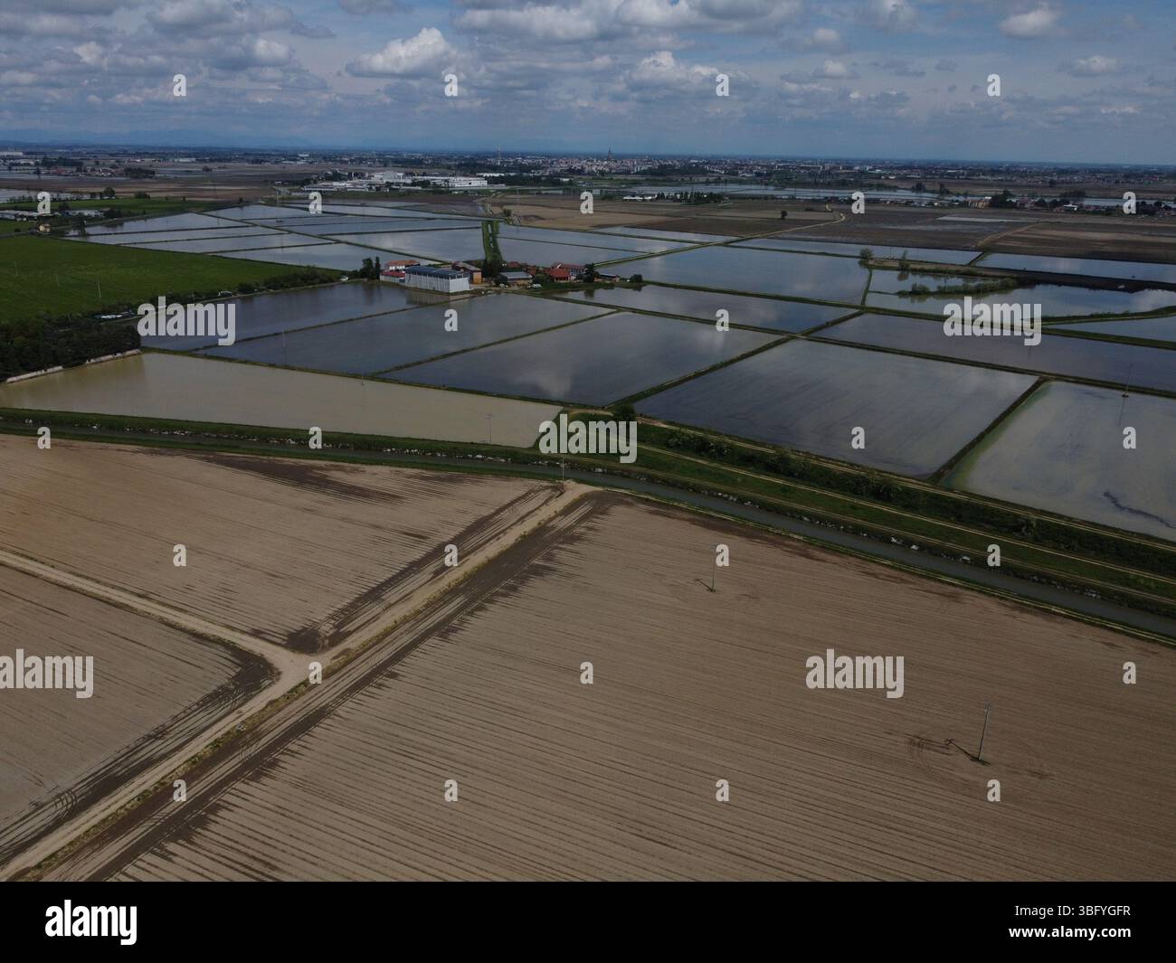 Drone view of Novara’s countryside with flooded rice fields reflecting ...