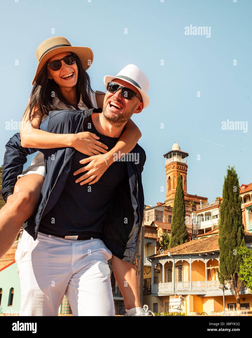 Romantic Couple tourists having fun walking Tbilisi city streets on ...