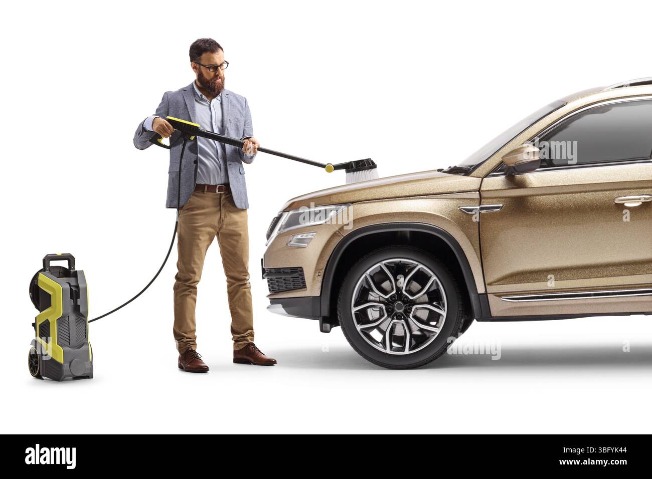 Man using a pressure washer and brushing SUV isolated on white ...