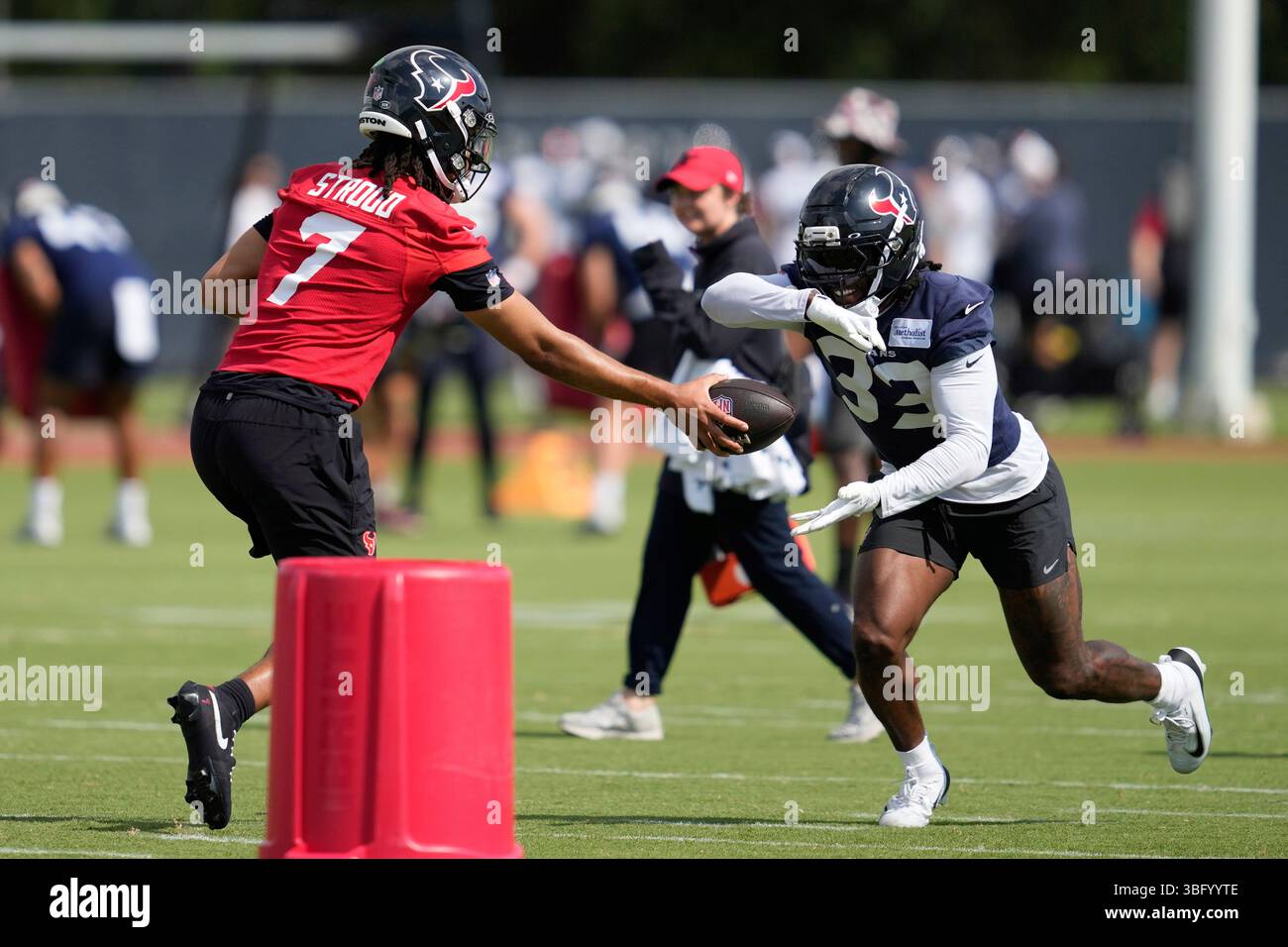 Houston Texans quarterback C.J. Stroud (7) hands off to running back ...